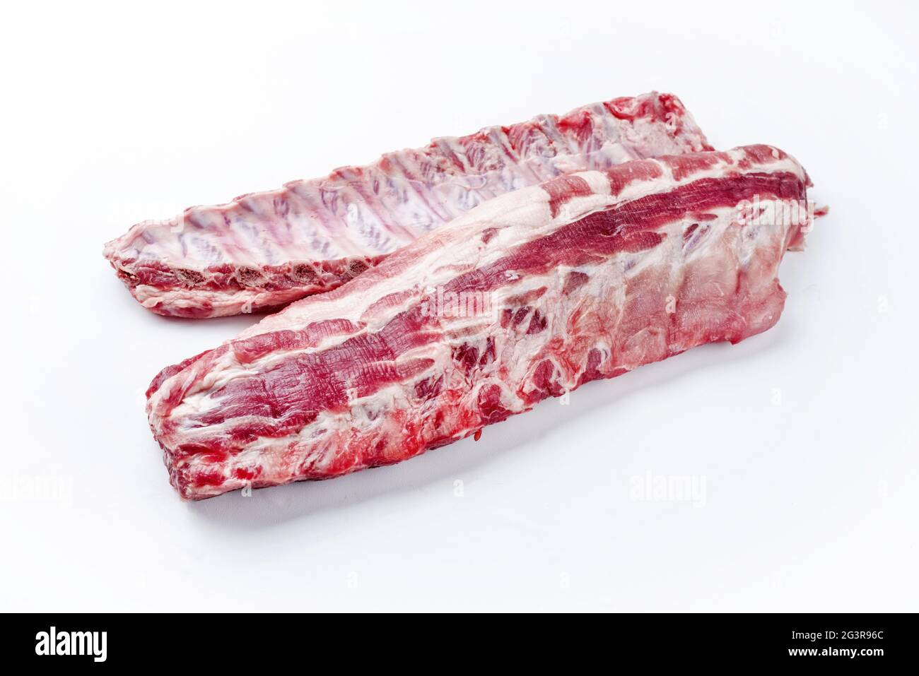 Raw pork spare loin ribs St Louis cut offered as closeup on white ...