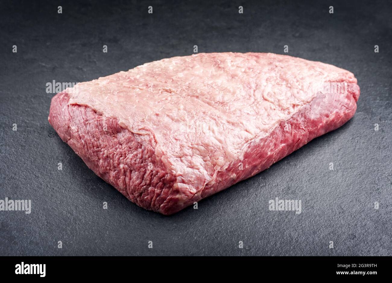 Raw dry aged wagyu cap of rump beef offered as close-up on black ...