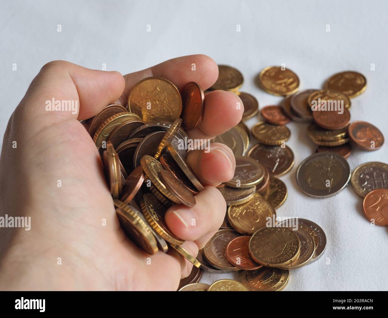 Hand giving money euro coins hi-res stock photography and images - Alamy