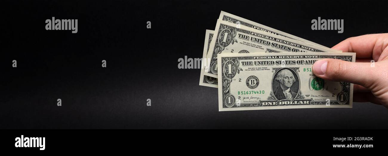 Money in hand, banknote in hand. Hand holding one dollar banknote ...