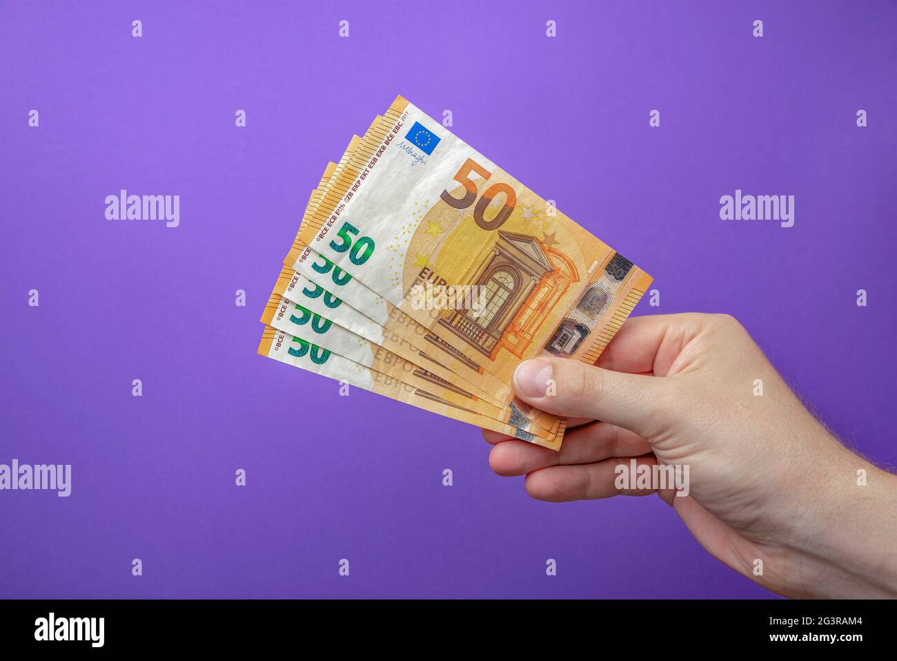Money in hand, poster with banknote in hand. Hand holding 50 euro ...