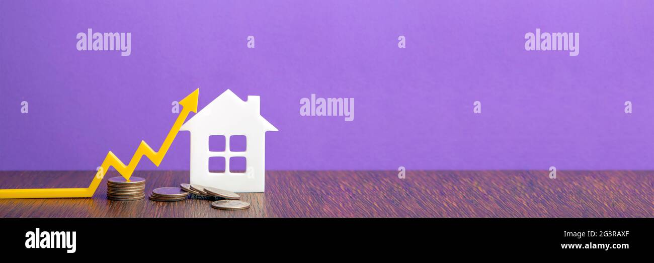 Real estate market, graph, up arrow. House construction model and a ...