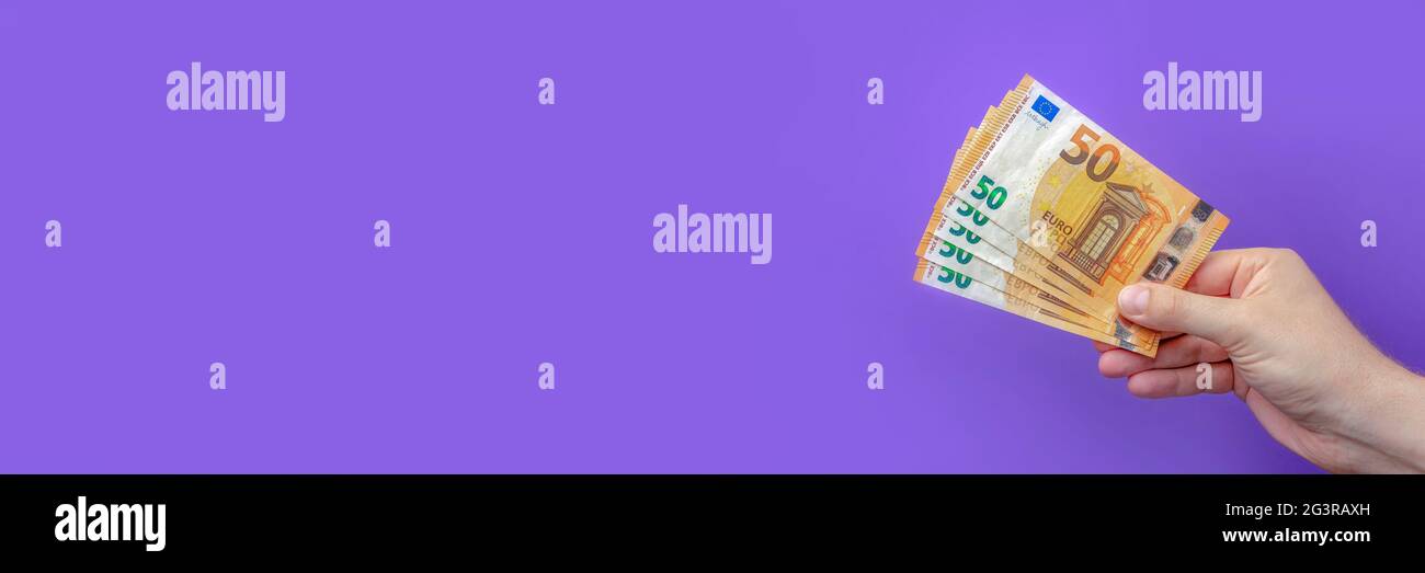 Money in hand, poster with banknote in hand. Hand holding 50 euro ...