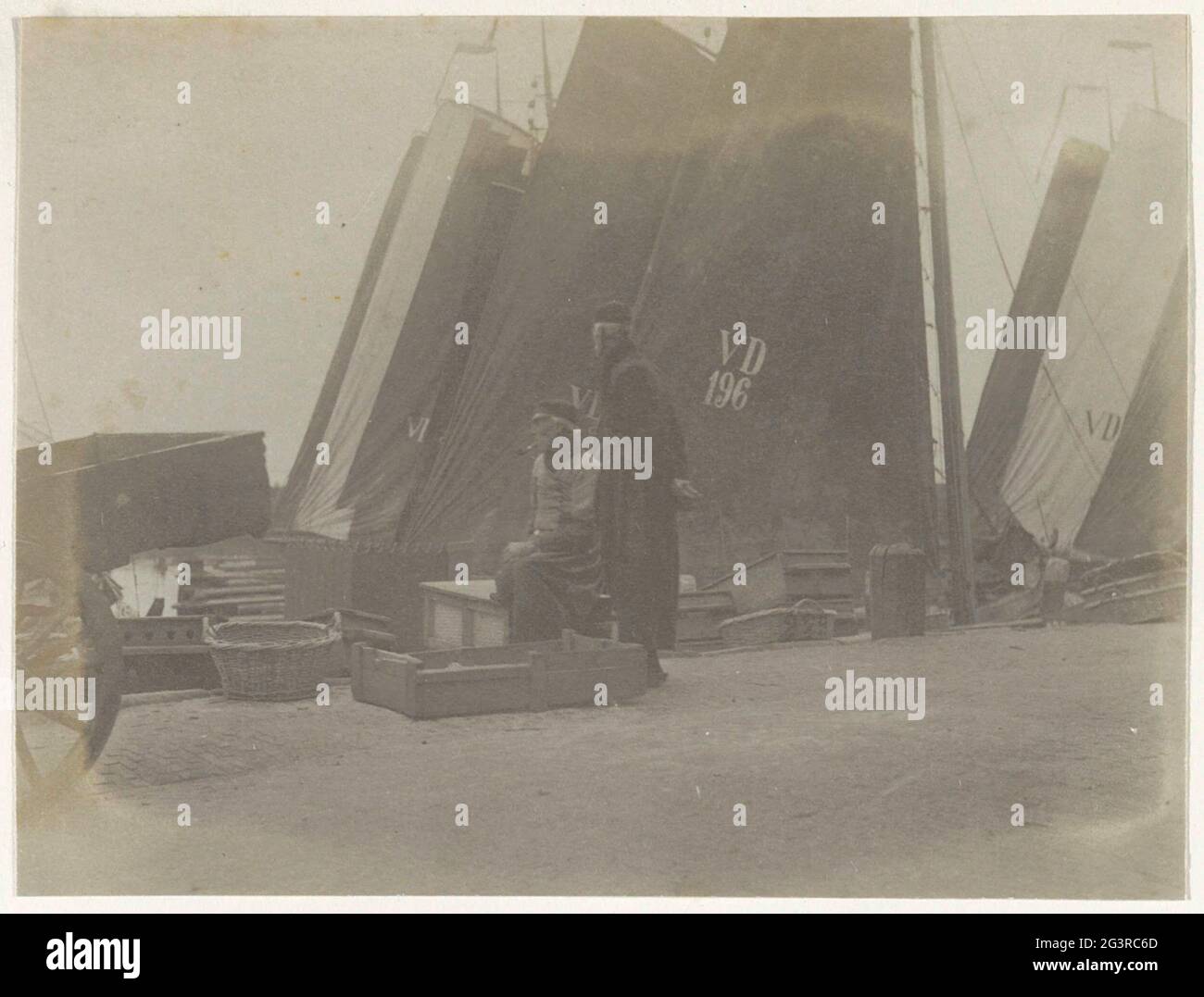 Men in Volendam traditional costume on a quay. Part of photo album with ...