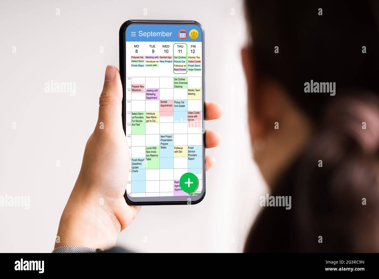 Executive Looking At Calendar On Mobile Phone. Arranging Weekly ...