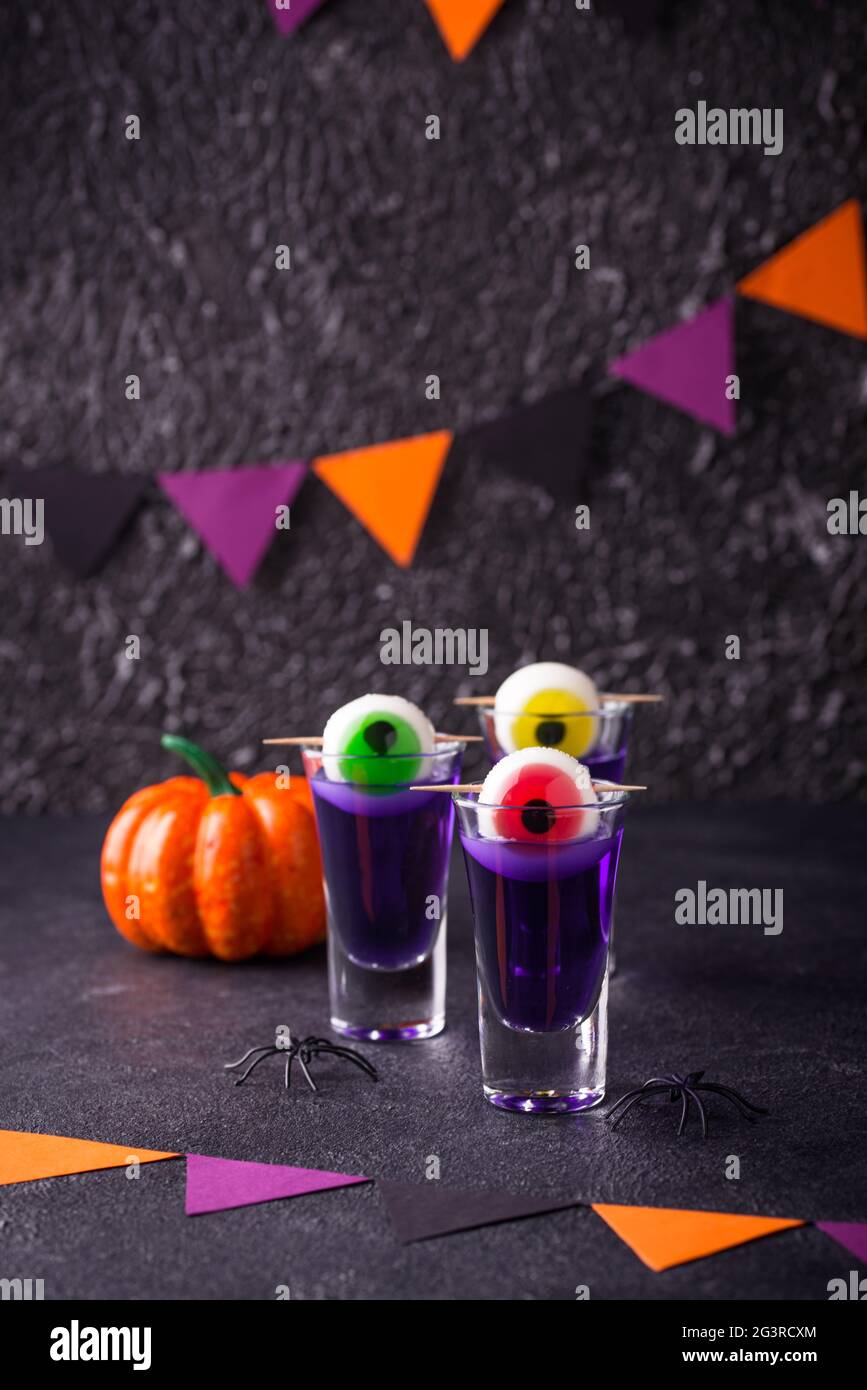 Halloween purple cocktail with eyes Stock Photo - Alamy