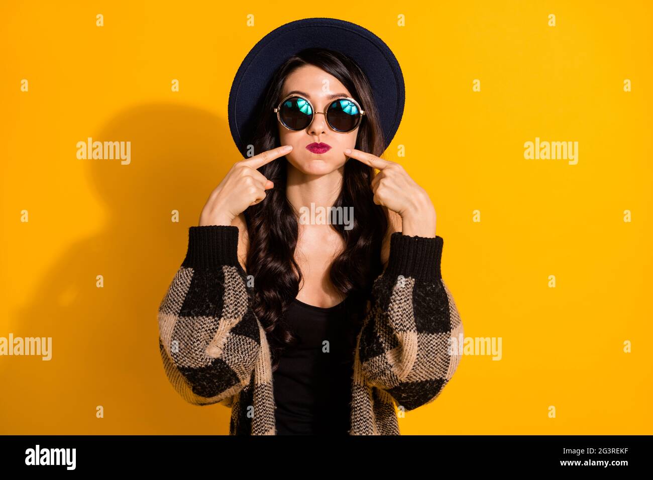 Photo of funny foolish lady puffed cheeks direct fingers wear glasses ...