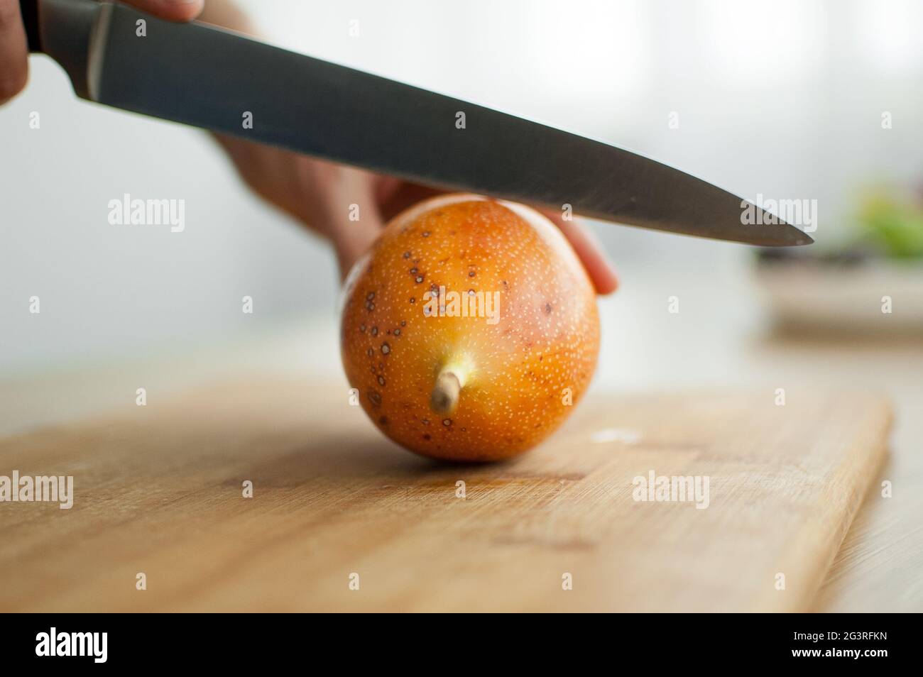 Fresh organic ripe granadilla or yellow passion fruit cut in half on a ...