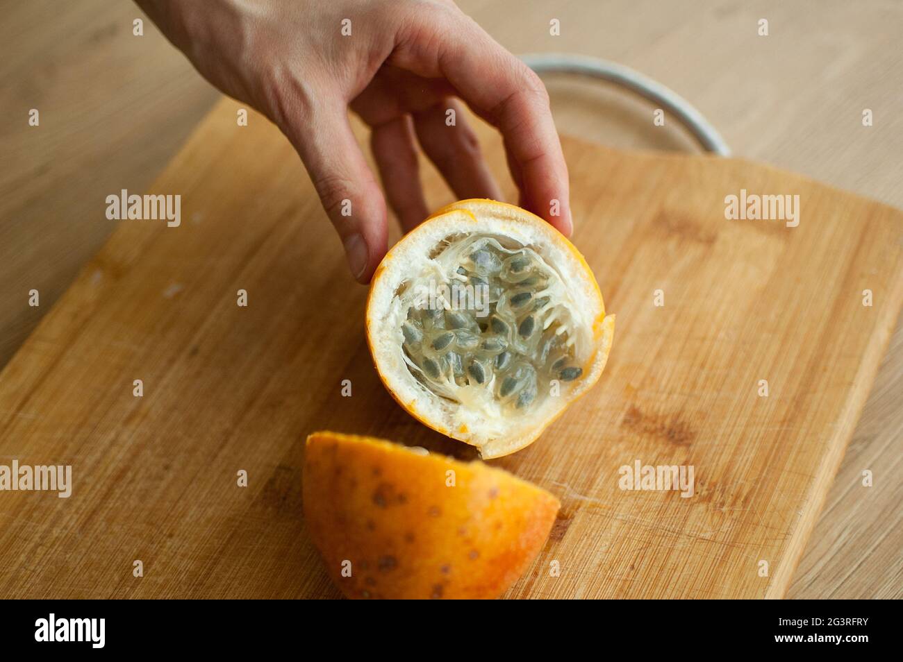 Fresh organic ripe granadilla or yellow passion fruit cut in half on a ...