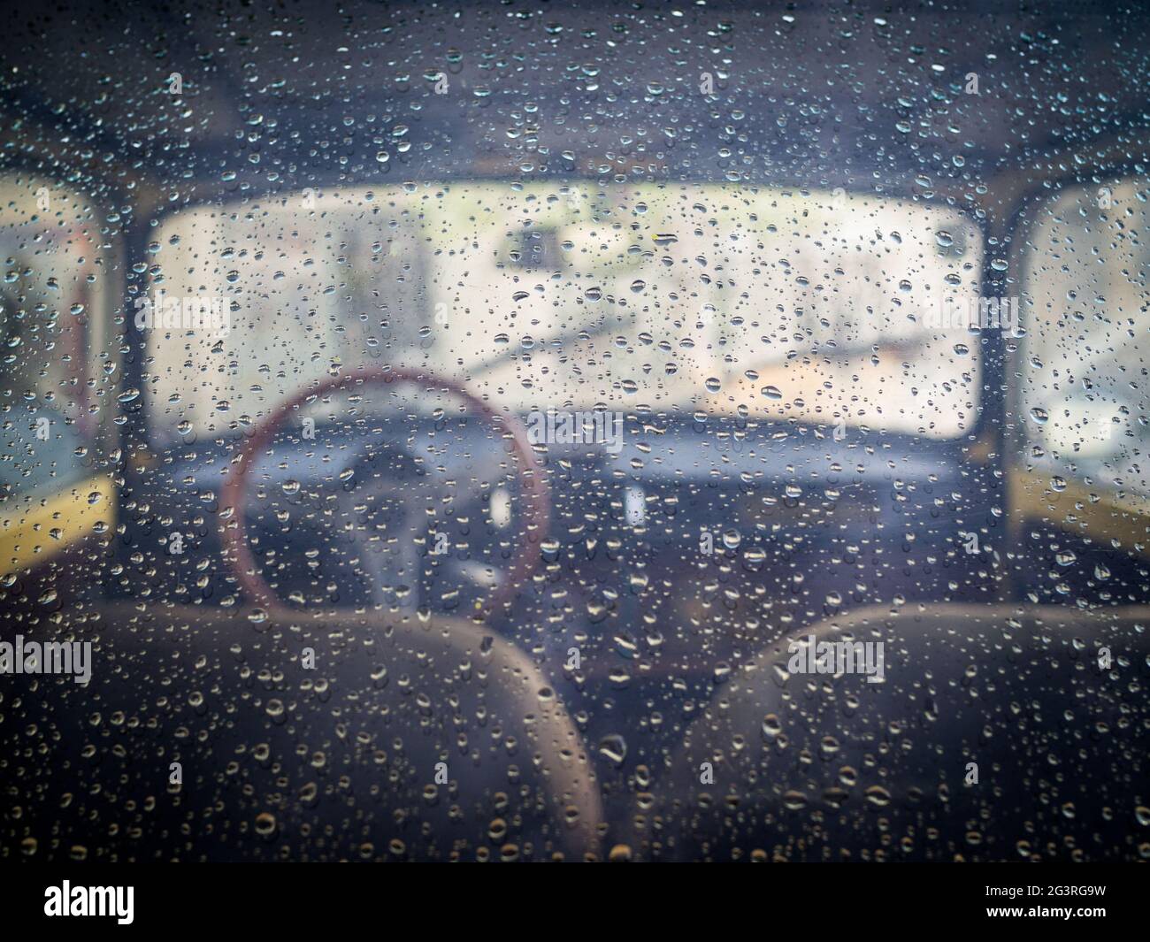 Rear window view into a classic oldtimmer with raindrops Stock Photo ...