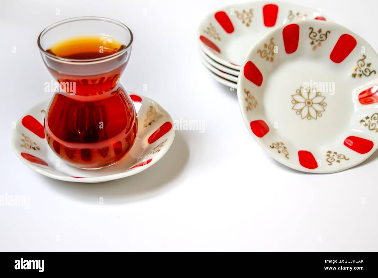 Tea plate decorated with traditional motifs and black tea in a thin ...