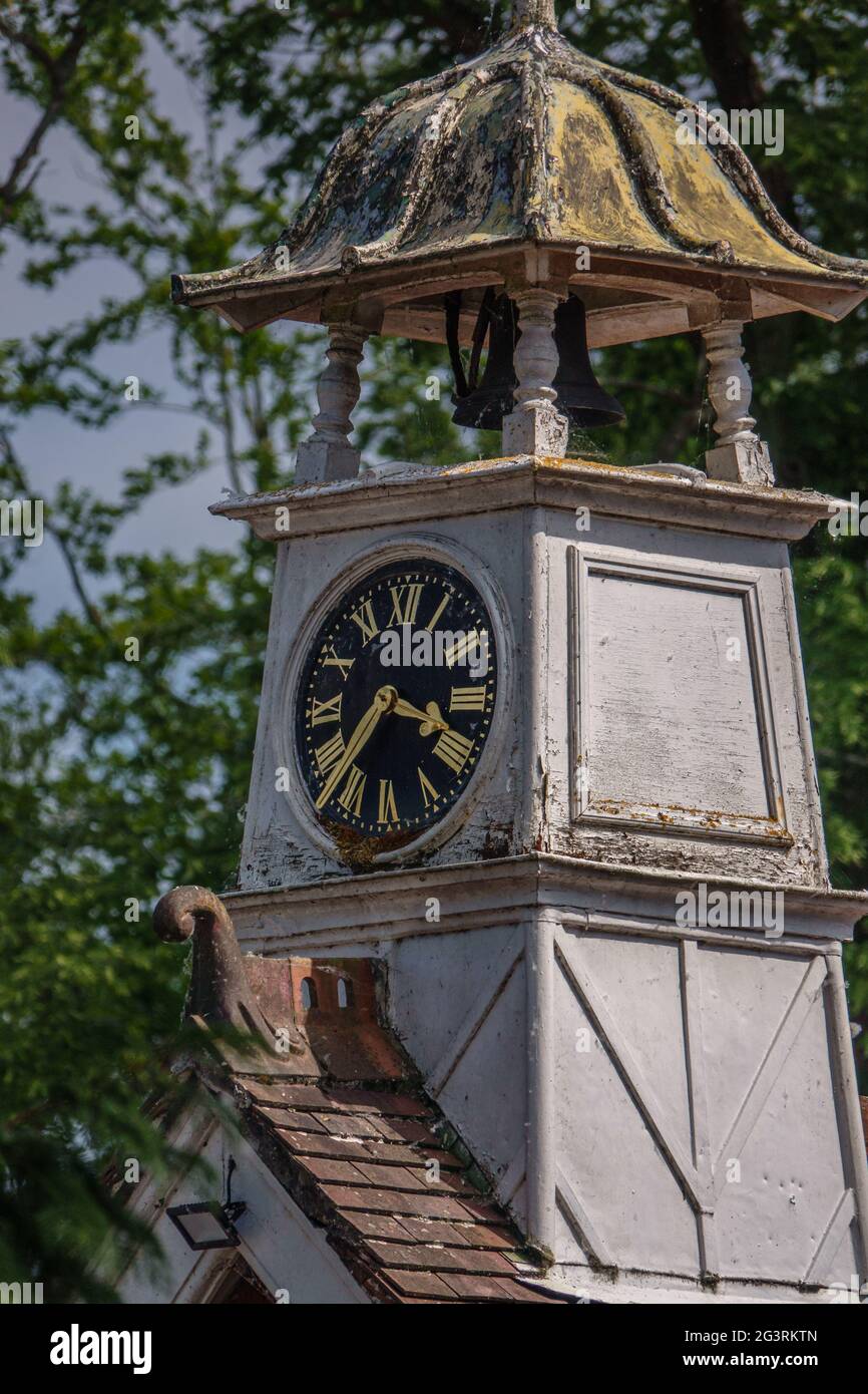 a clock and bell tower on a red tiled rooftop in Wiltshire Stock Photo ...
