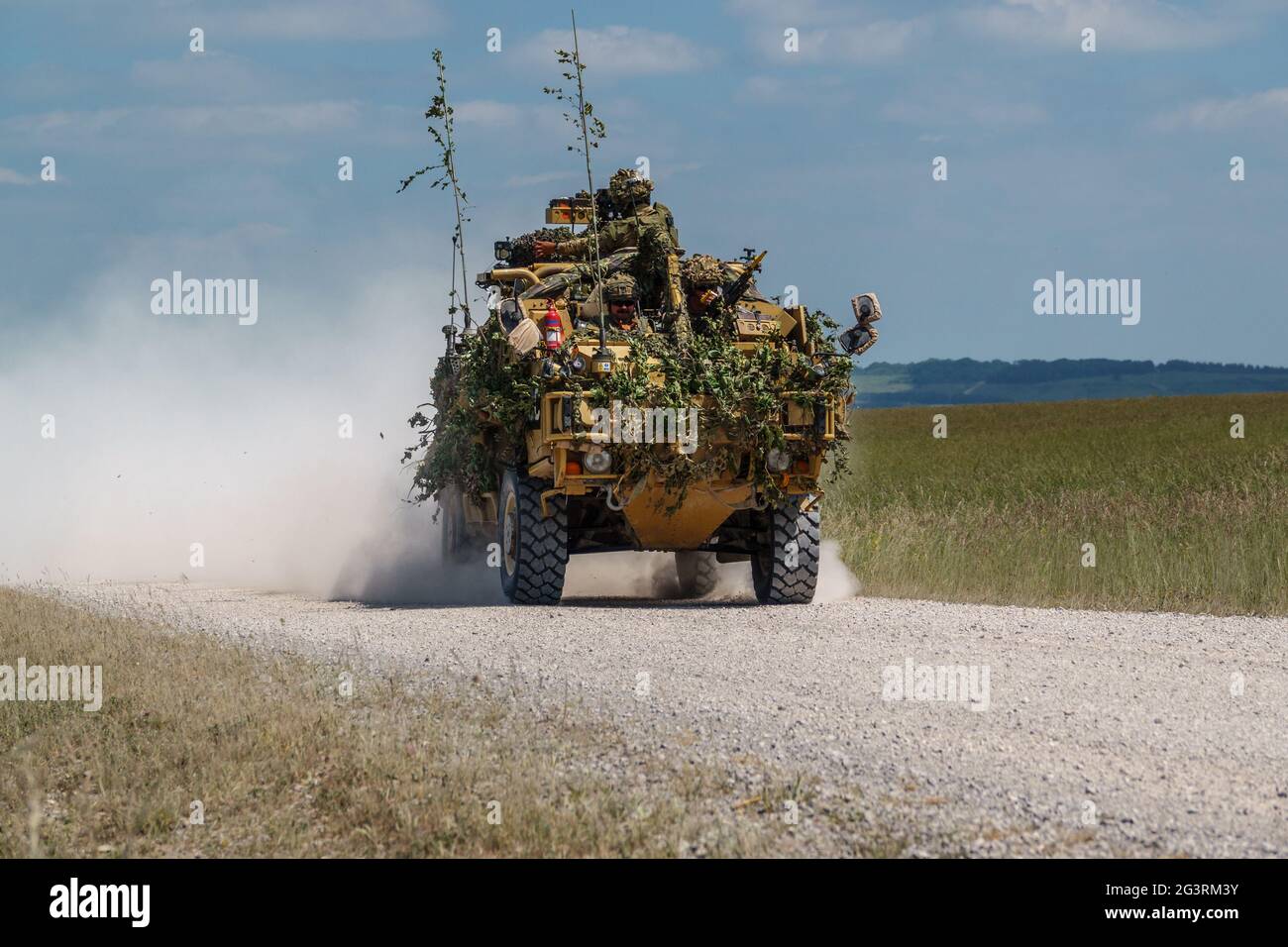 British Army Supacat HMT 400, 4x4 in high speed action over a dusty ...
