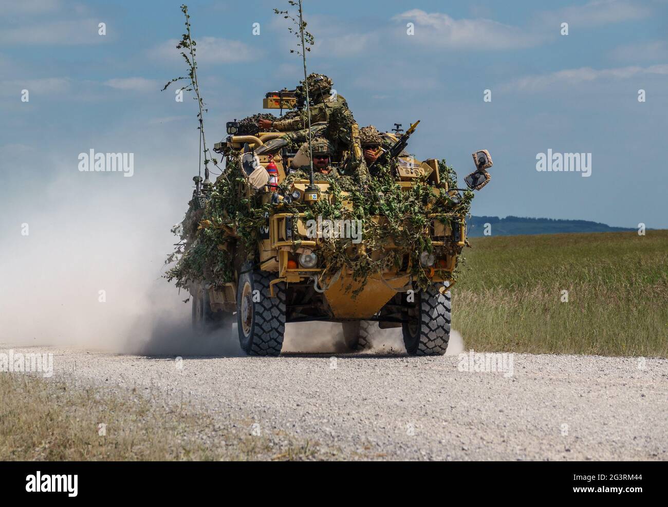 British Army Supacat HMT 400, 4x4 in high speed action over a dusty ...