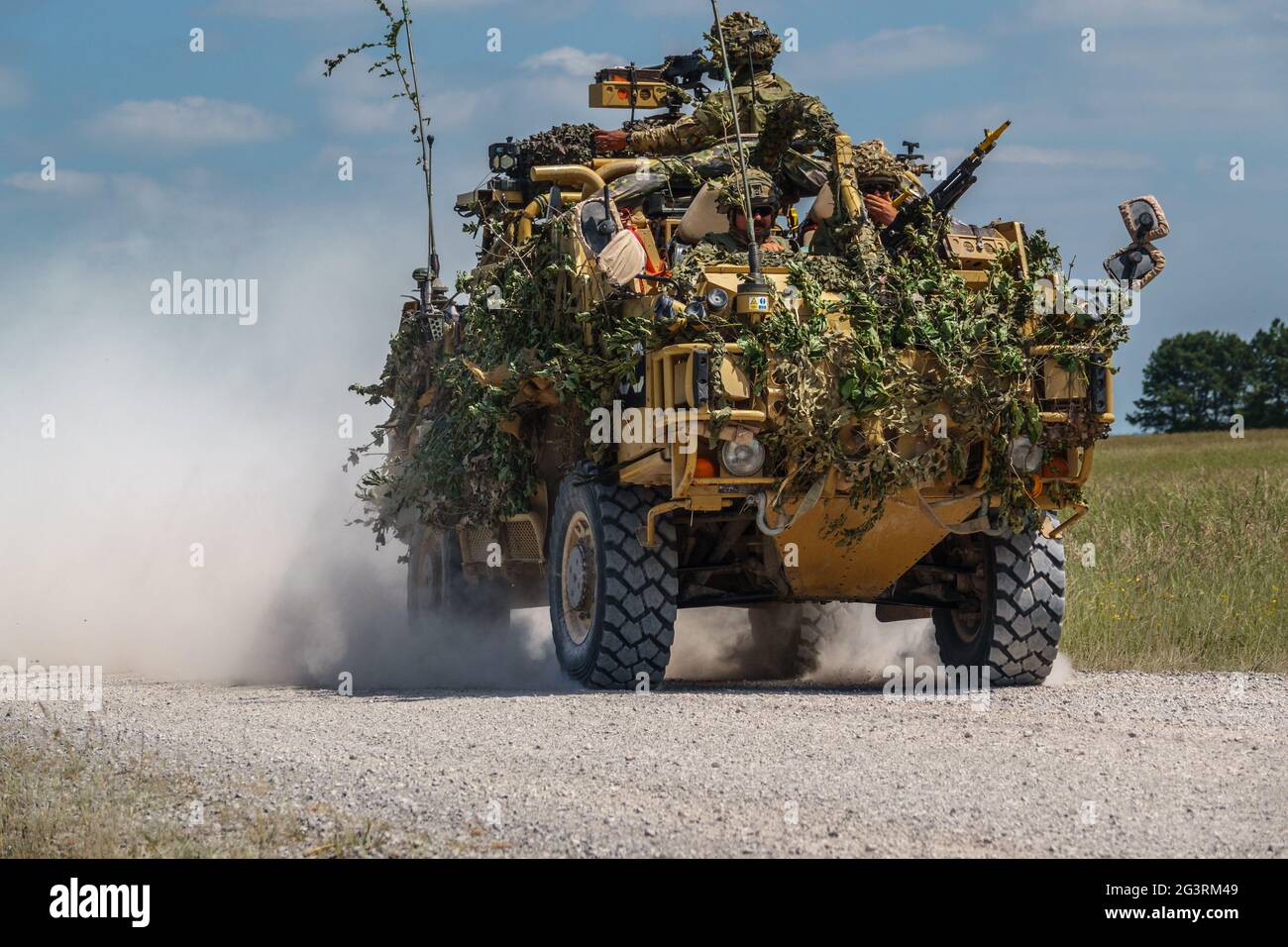 British Army Supacat HMT 400, 4x4 in high speed action over a dusty ...
