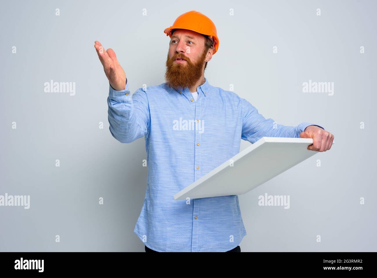 Confidant architect with beard and orange helmet does a sketch Stock ...