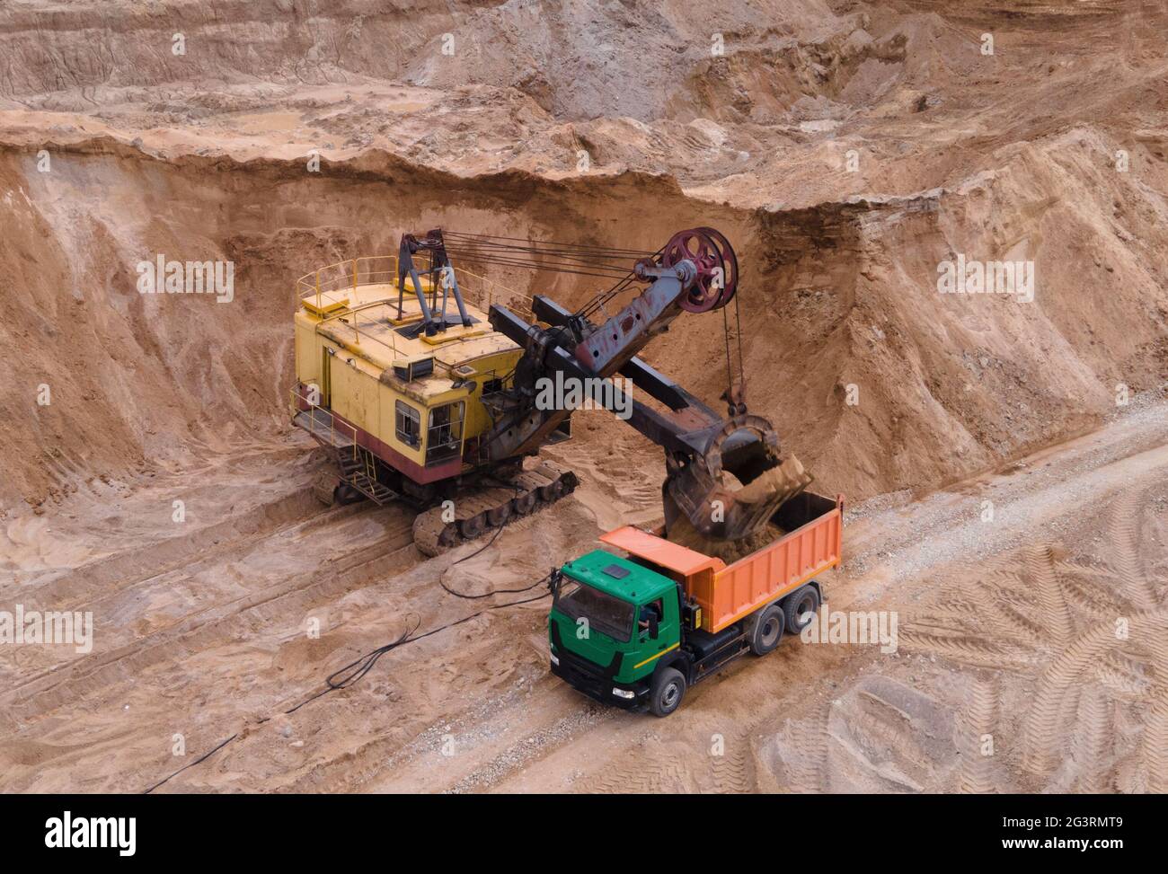Largest mining excavator with electric shovel loading sand into dump ...