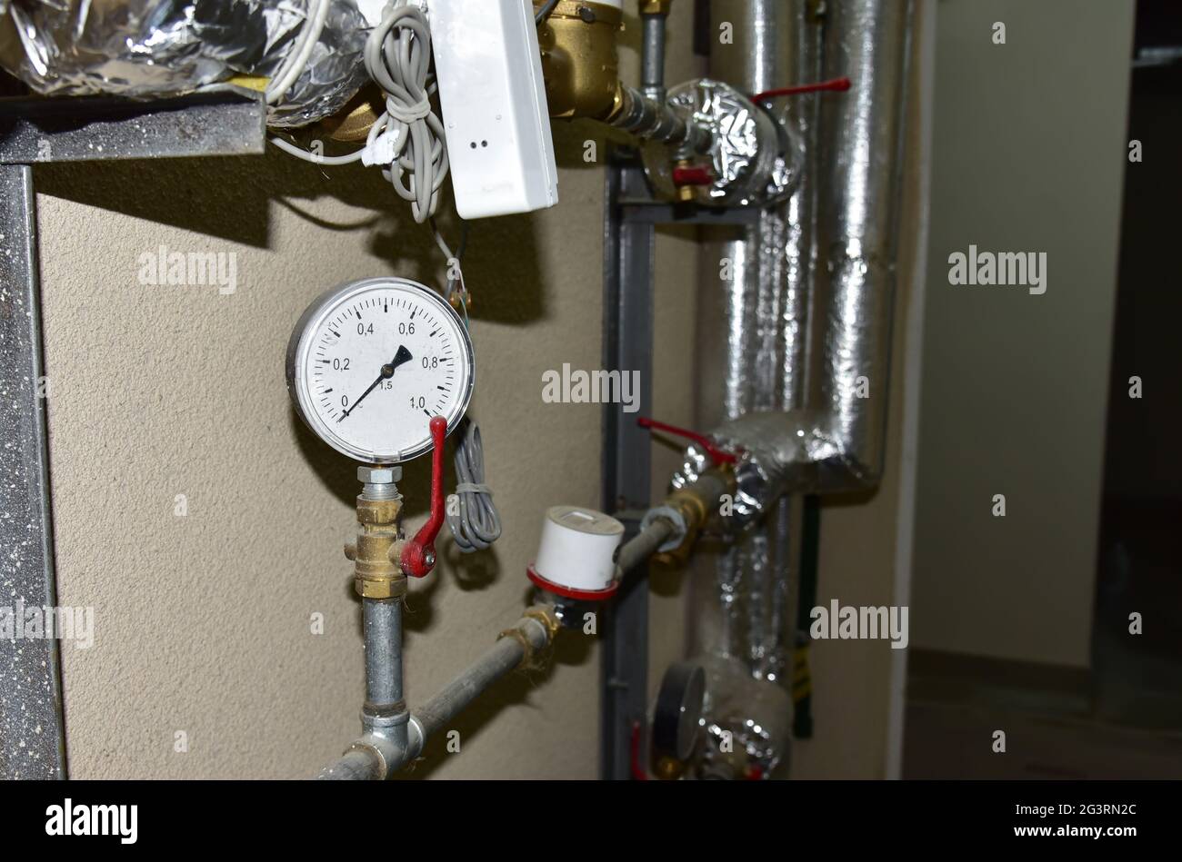 Heating system in boiler room at home. Round mechanical pressure gauge ...