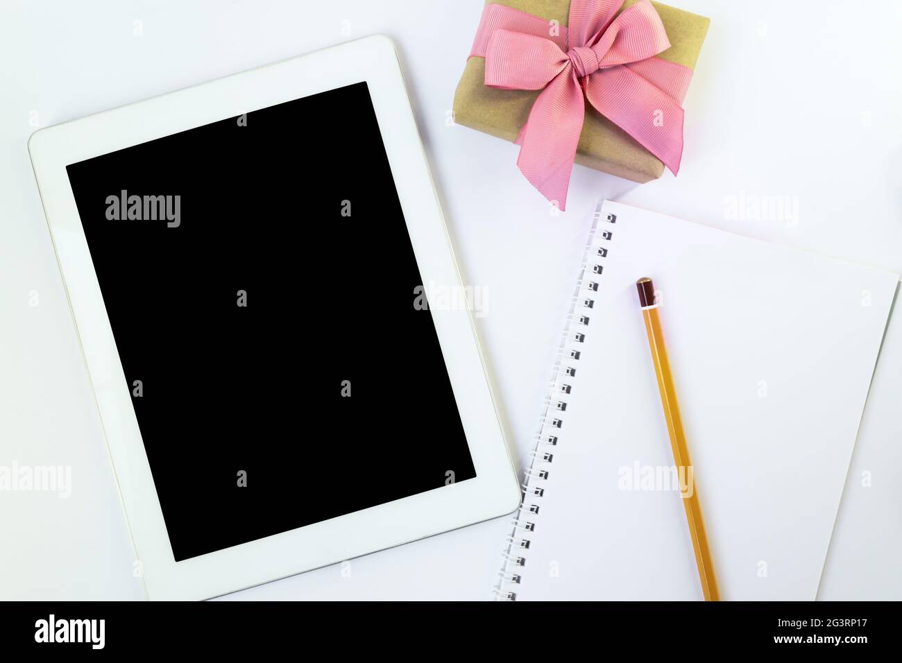 Notepad, tablet and gift box. Online shopping. Choosing gifts online ...