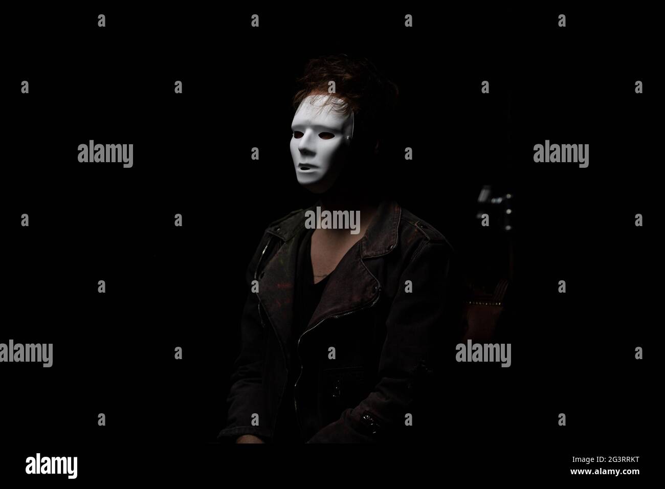 Actor wearing a face mask while acting on a dark stage Stock Photo - Alamy