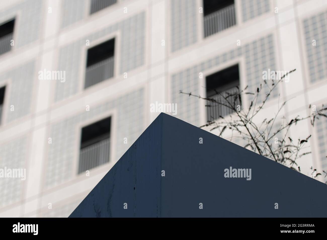Low angle shot of a modern building in front of a skyscraper Stock ...