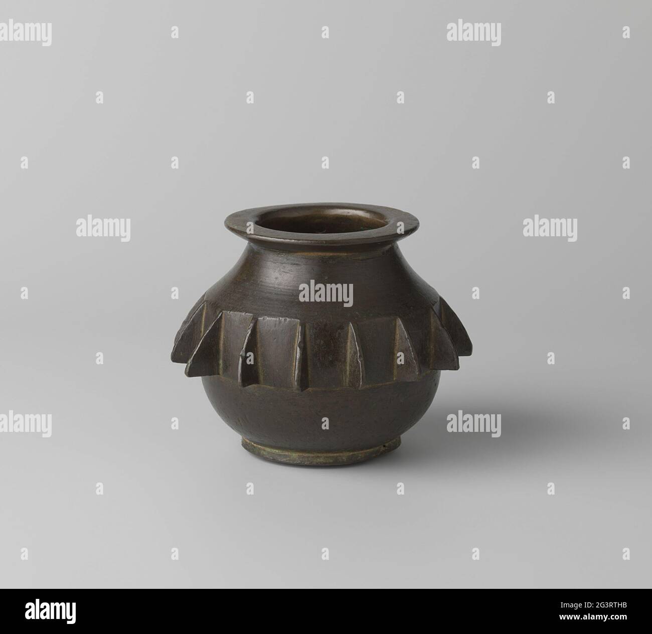 Bullet-shaped mortar, decorated with vin-shaped protrusions. The cast a ...