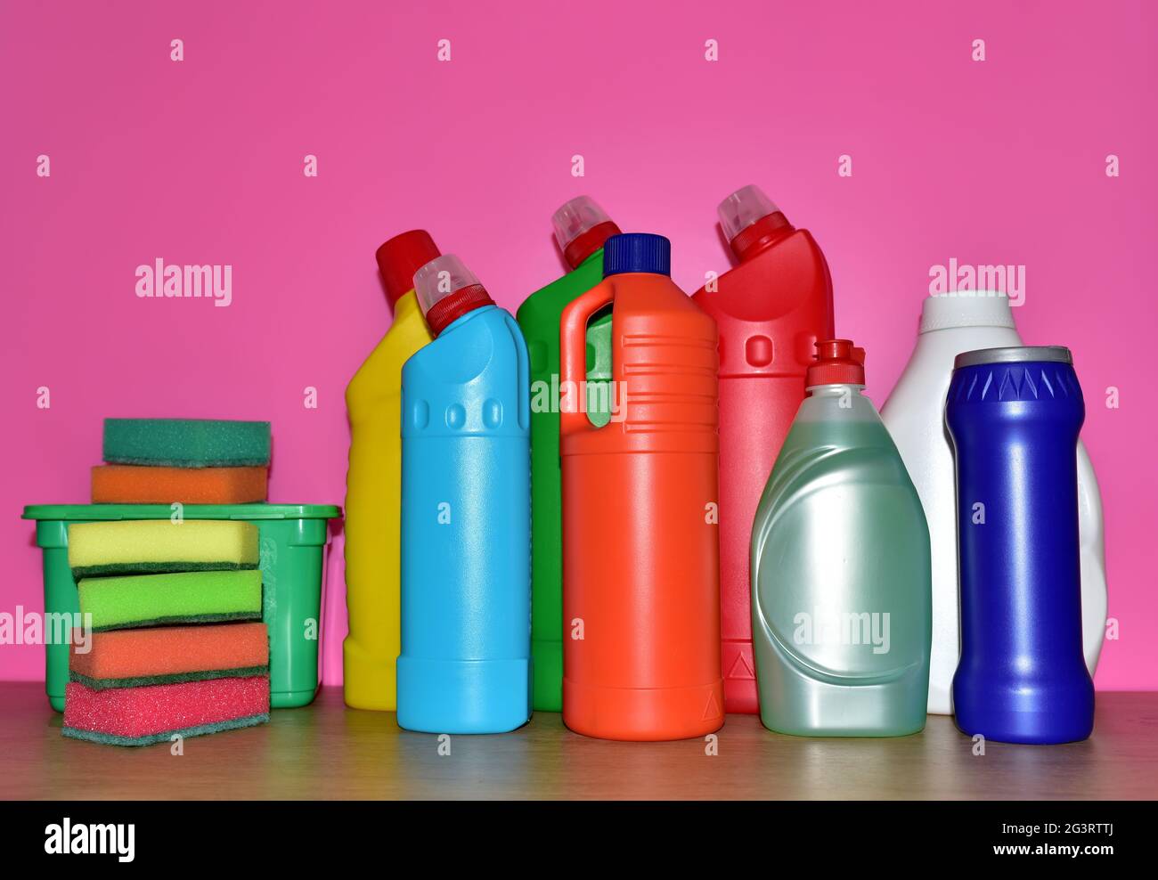 Detergent laundry bottles and sponge for washing on pink background ...