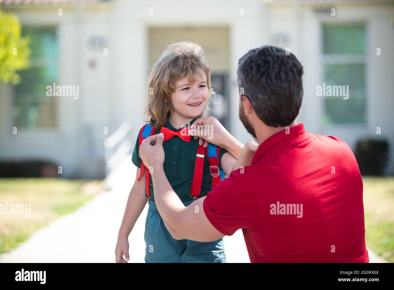 Father helping son ready to school. Father supports and motivates son ...