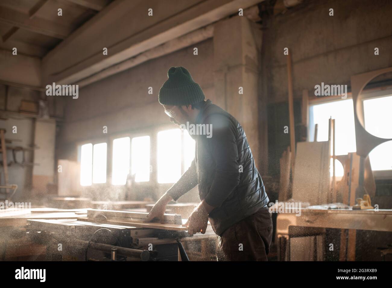 Male carpenter cutting wooden plank Stock Photo - Alamy