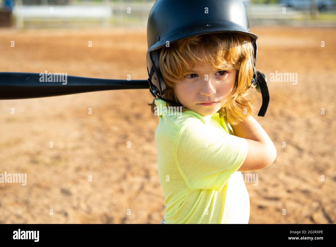 Child baseball player focused ready to bat. Kid holding a baseball bat ...
