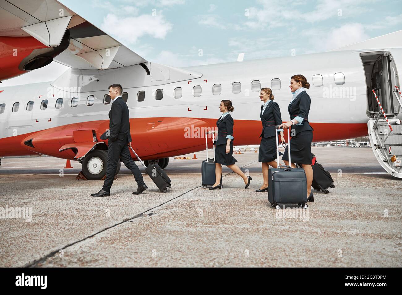 Plane team walking on runway from airplane Stock Photo - Alamy