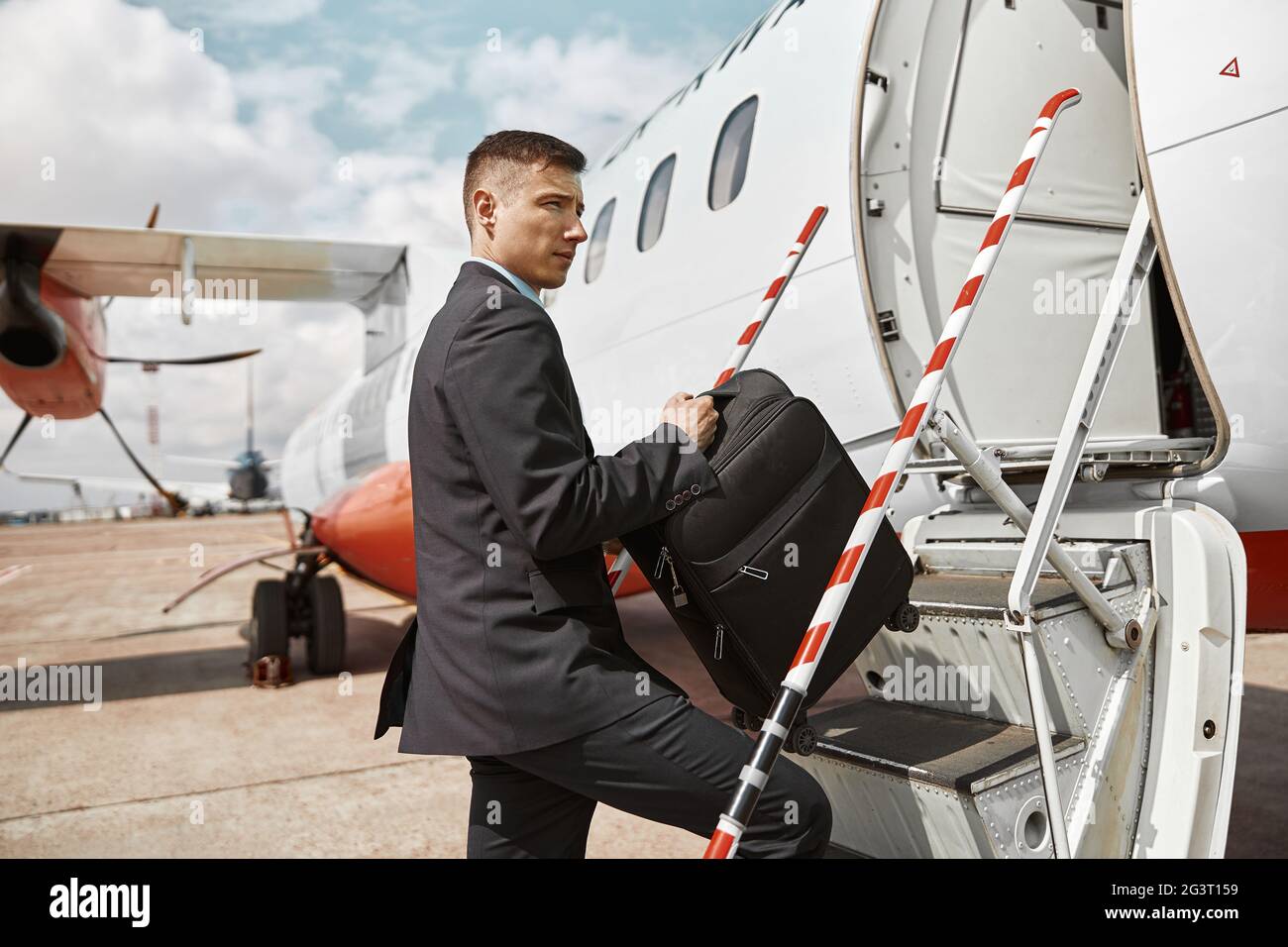 Flight attendant going up on ladder to airplane Stock Photo - Alamy
