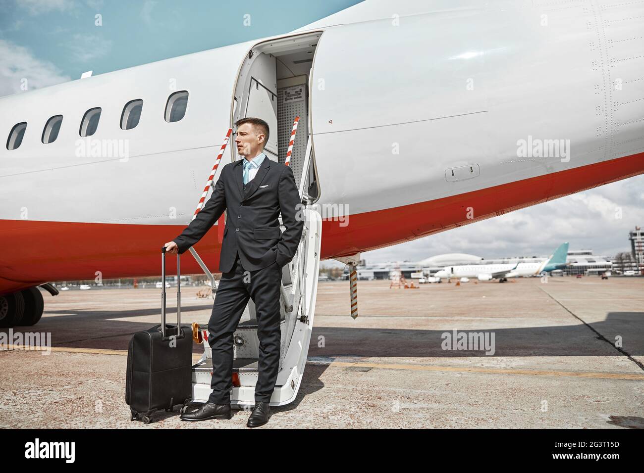 Flight attendant stand on runway near airplane jet Stock Photo - Alamy