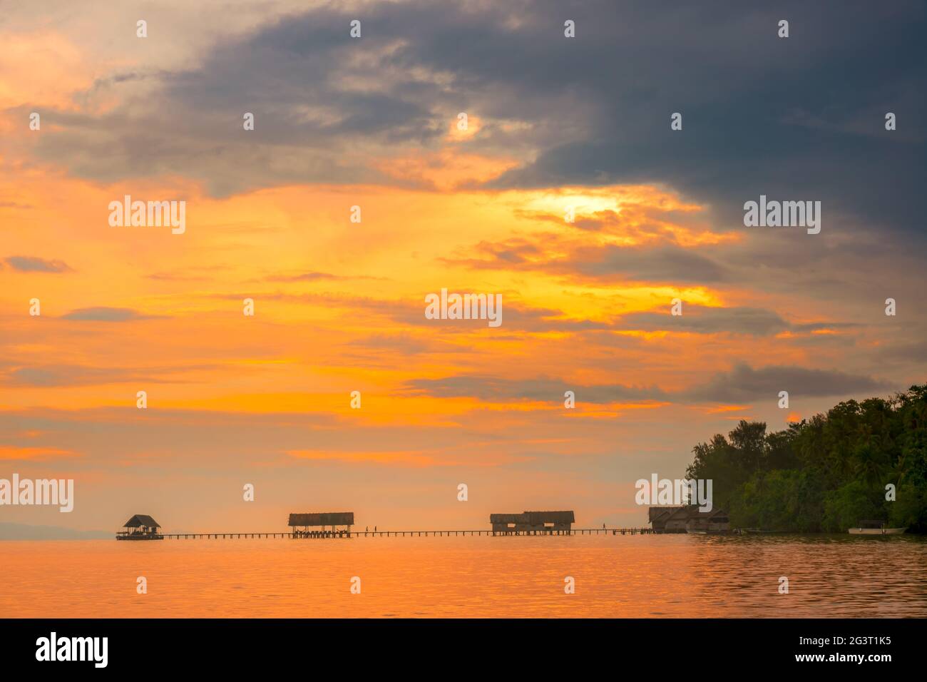 Wooden Pier, Huts and Tropical Sunset Stock Photo - Alamy