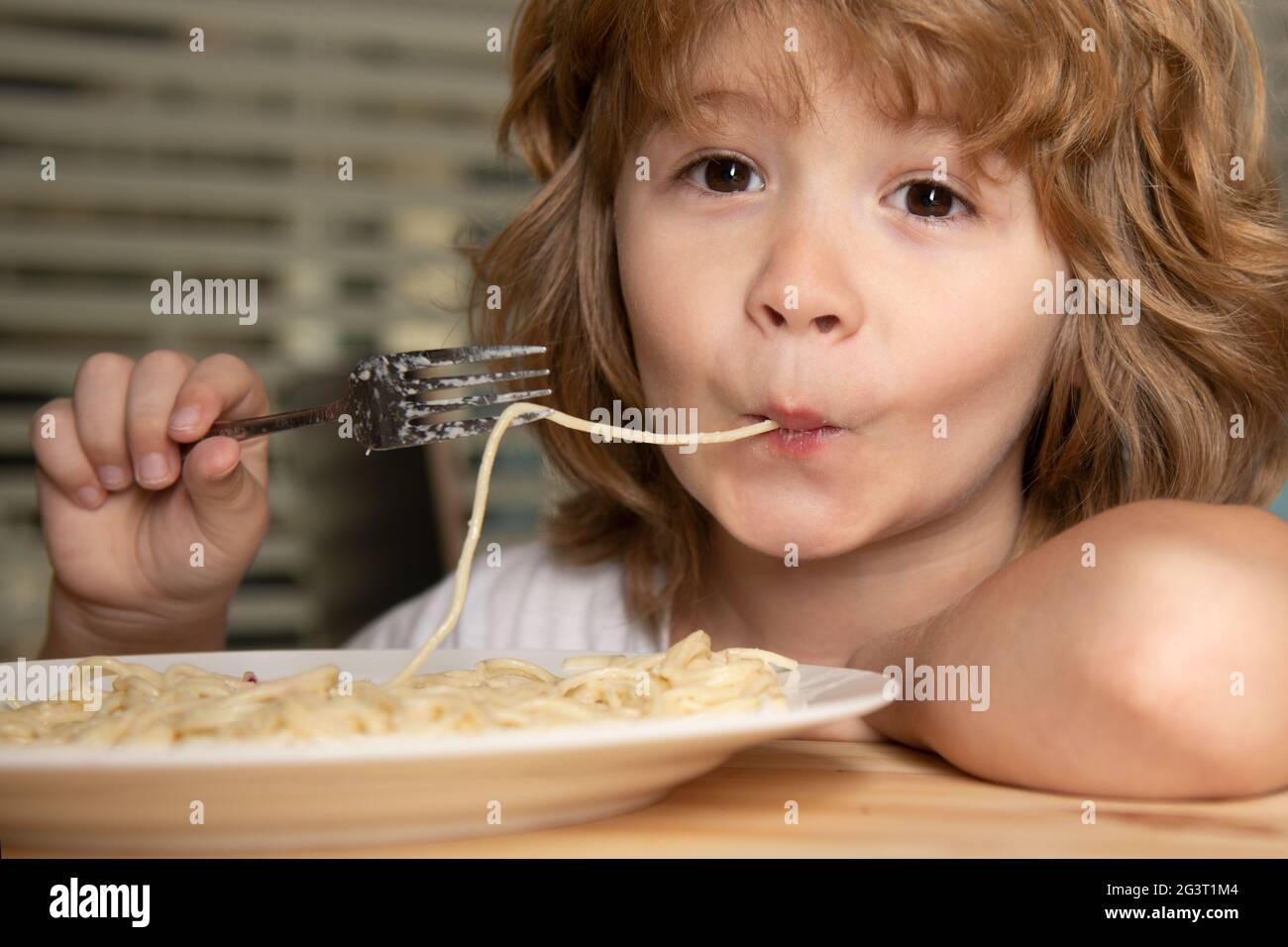 Kids eating pasta, spaghetti, close up cute funny child Stock Photo - Alamy