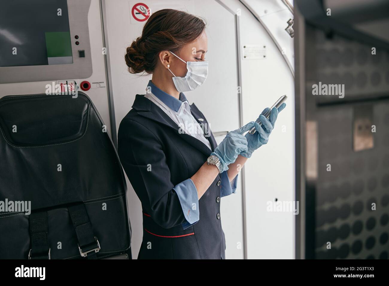 Stewardess use mobile phone in passenger airplane Stock Photo - Alamy