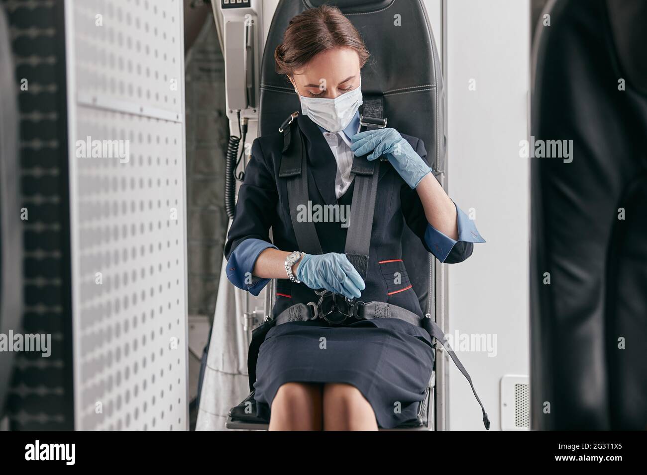 Woman plane seat belt hi-res stock photography and images - Alamy