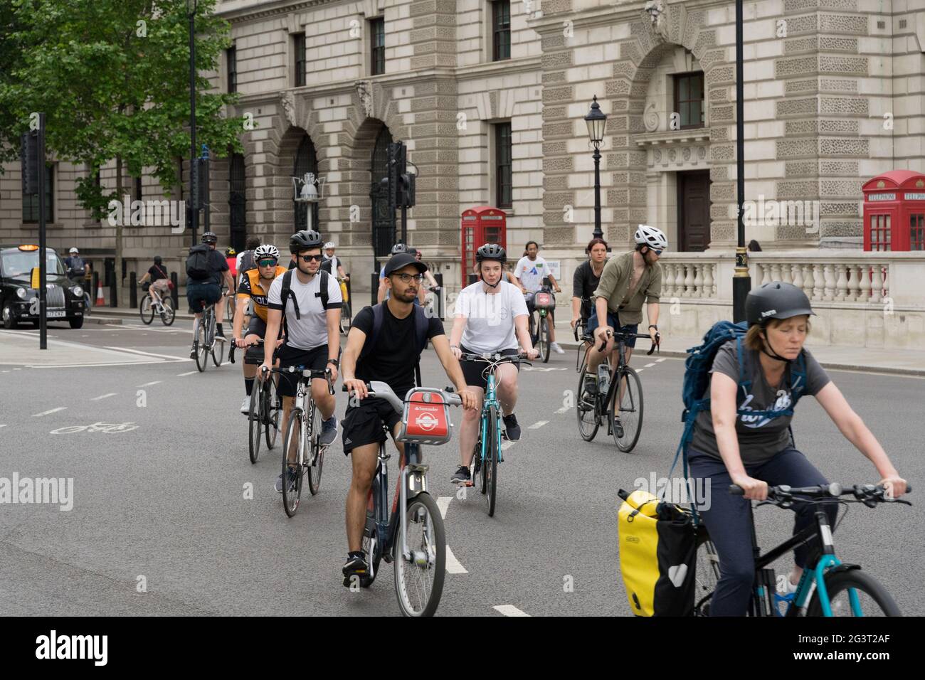 at evening rush hour, Cyclists crossing the road near Parliament square ...