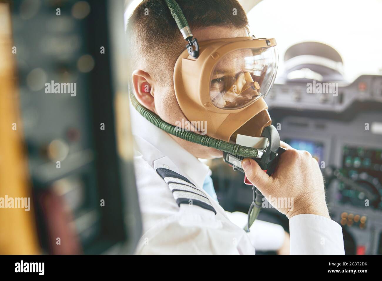 Male pilot take off air mask in cockpit of plane Stock Photo - Alamy