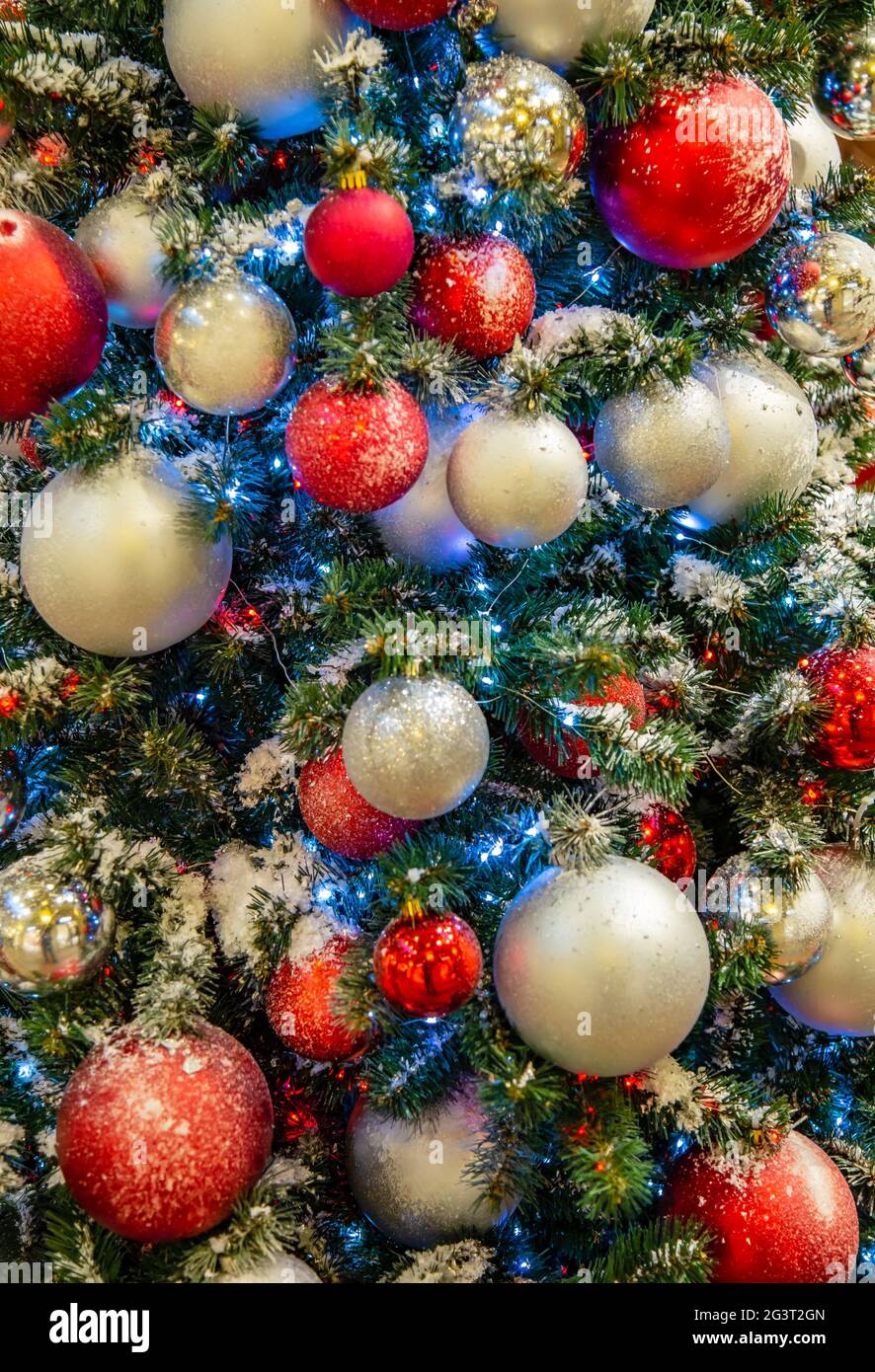 Christmas background with fir tree branches, decorations and blurred ...