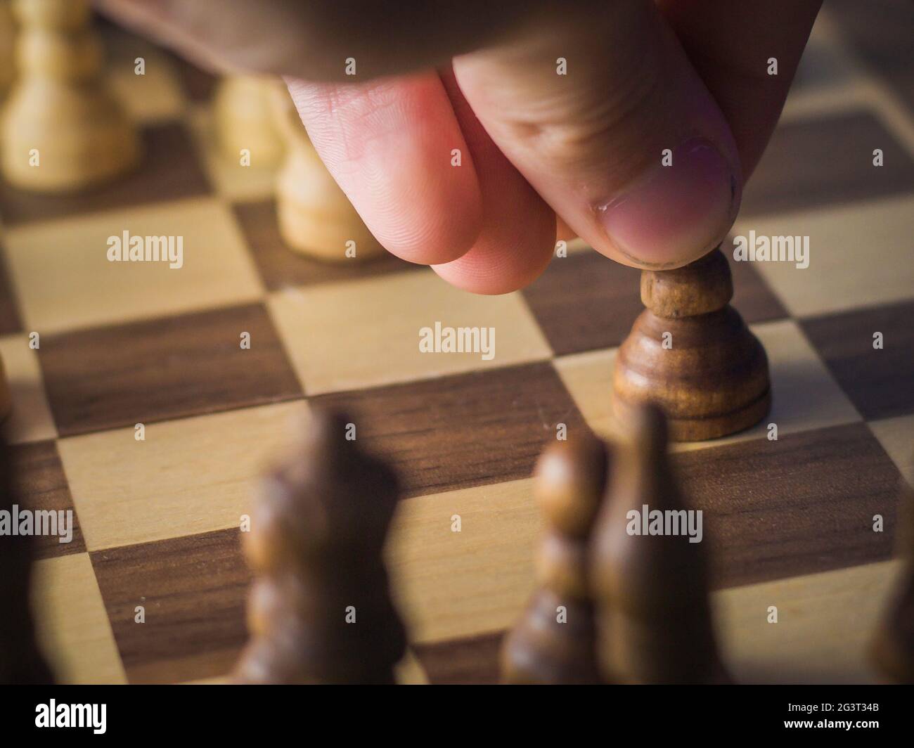 Person moving a chess piece hi-res stock photography and images - Alamy