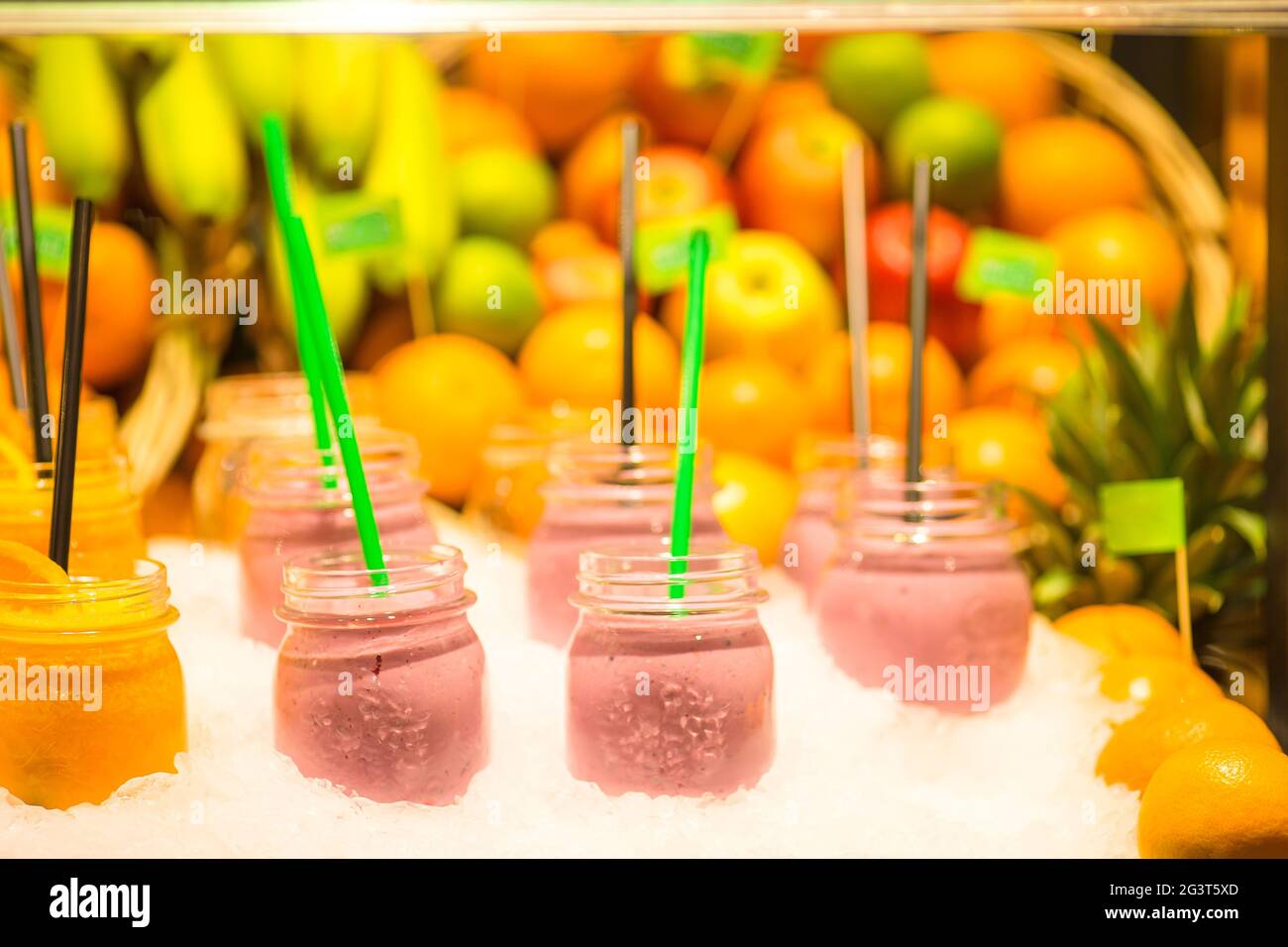 Row of healthy fresh fruit and vegetable smoothies with assorted ...