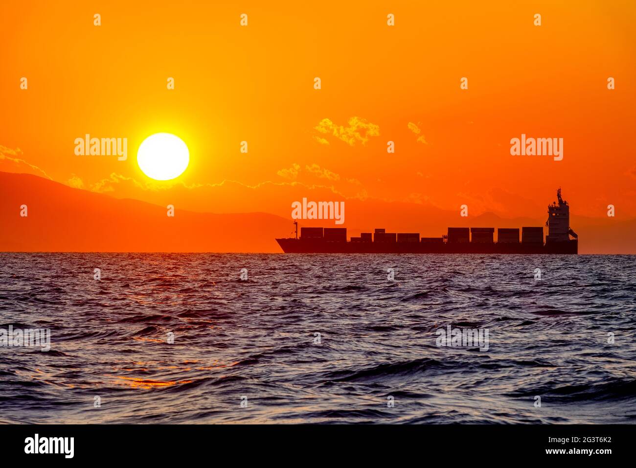 Container Ship in the Sea on a Background of Orange Sunset Stock Photo ...
