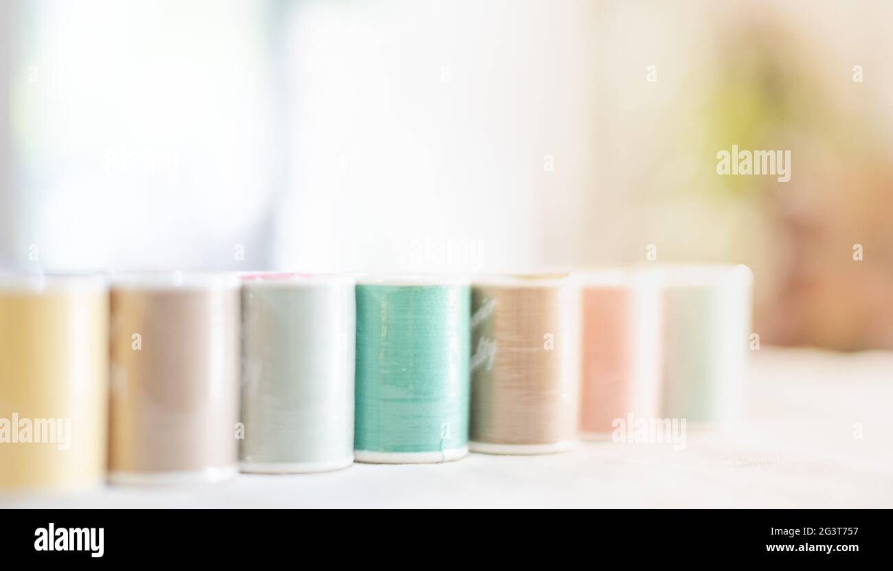 The pastel color embroidery thread spool using in garment industry, row ...