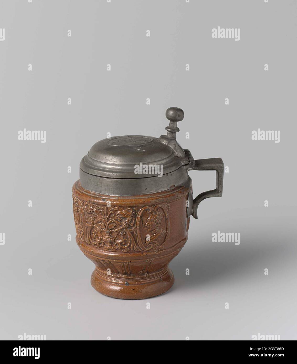 Jug. Low, cylindrical jug of stoneware with a tin lid and a tin angular ...