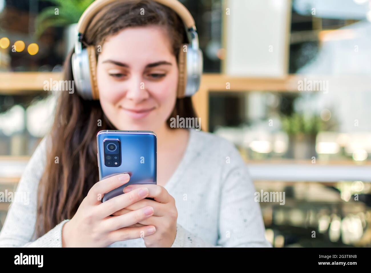 Young woman talking in video chat with her friend via smartphone Stock ...