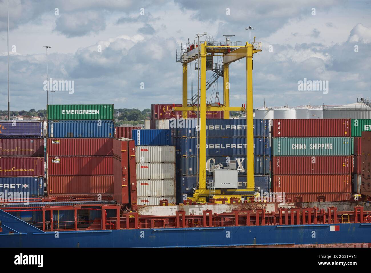 Large industrial cranes loading container ship in Dublin Port in ...