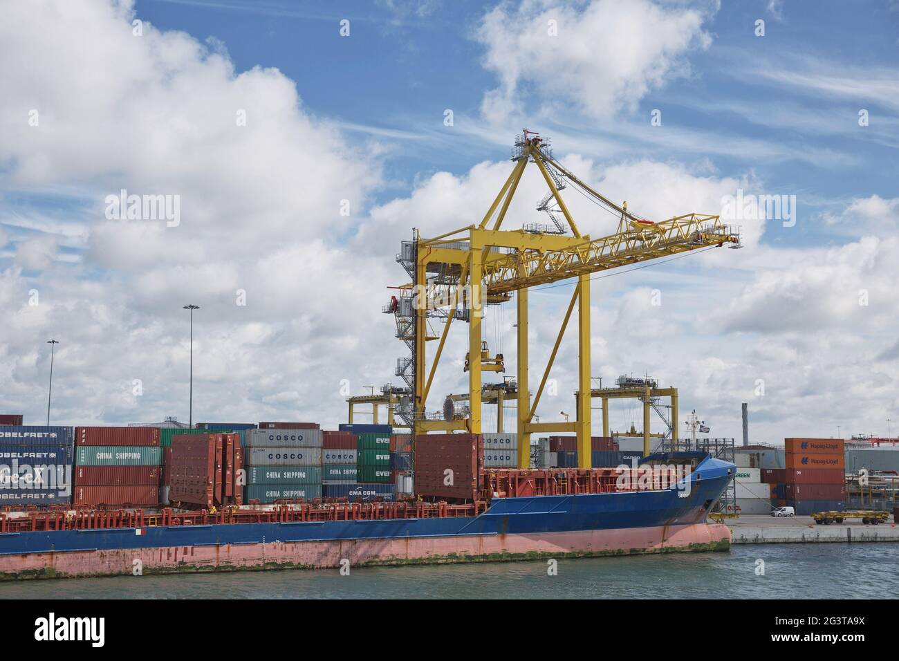 Large industrial cranes loading container ship in Dublin Port in ...