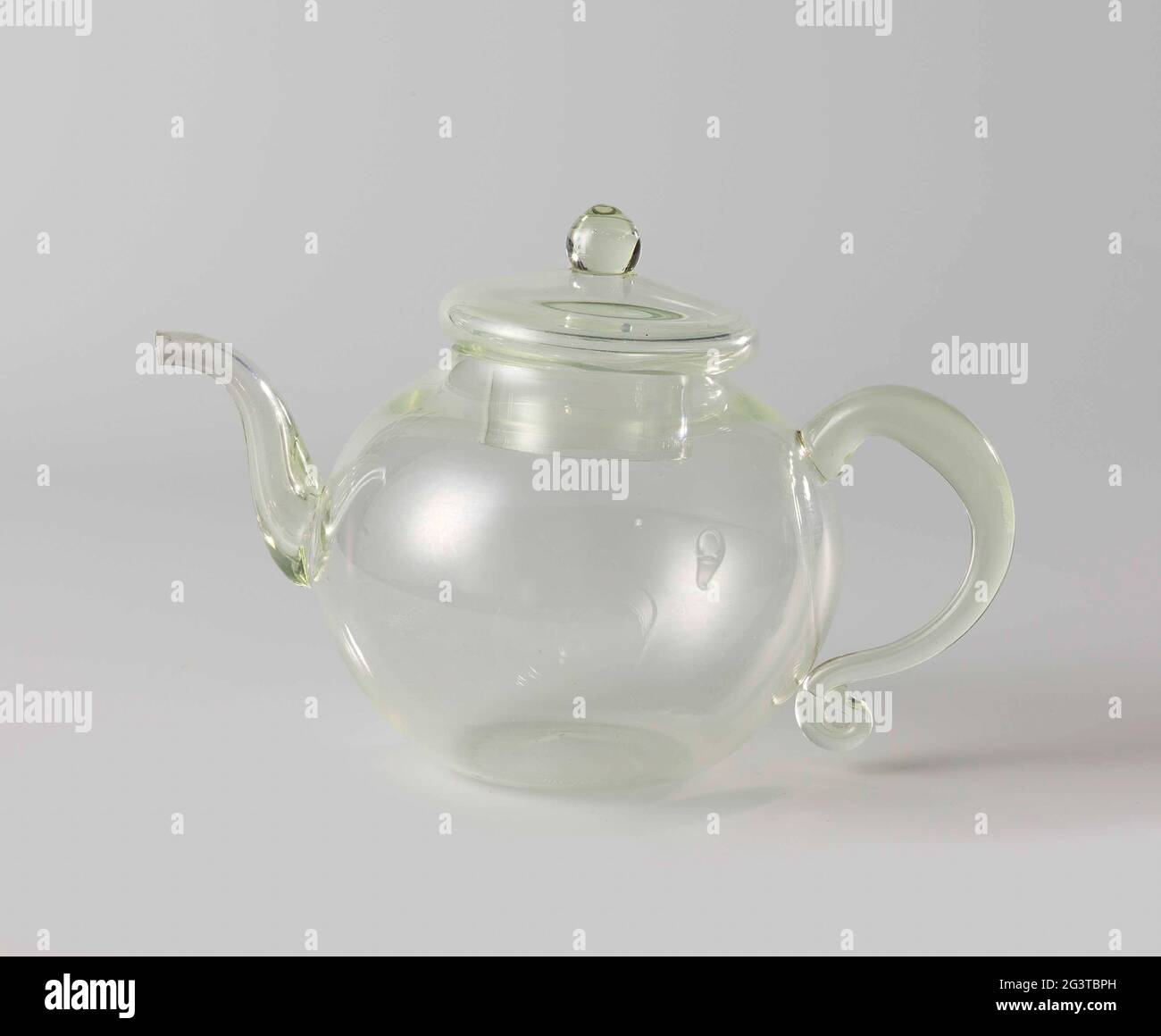 Teapot with lid. Spherical body, curved spout and c-shaped handle. Over ...
