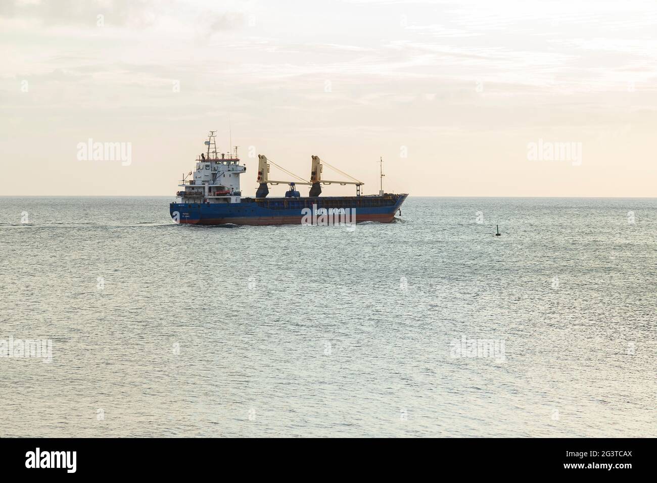 Cargo ship heading home after being offloaded Stock Photo - Alamy